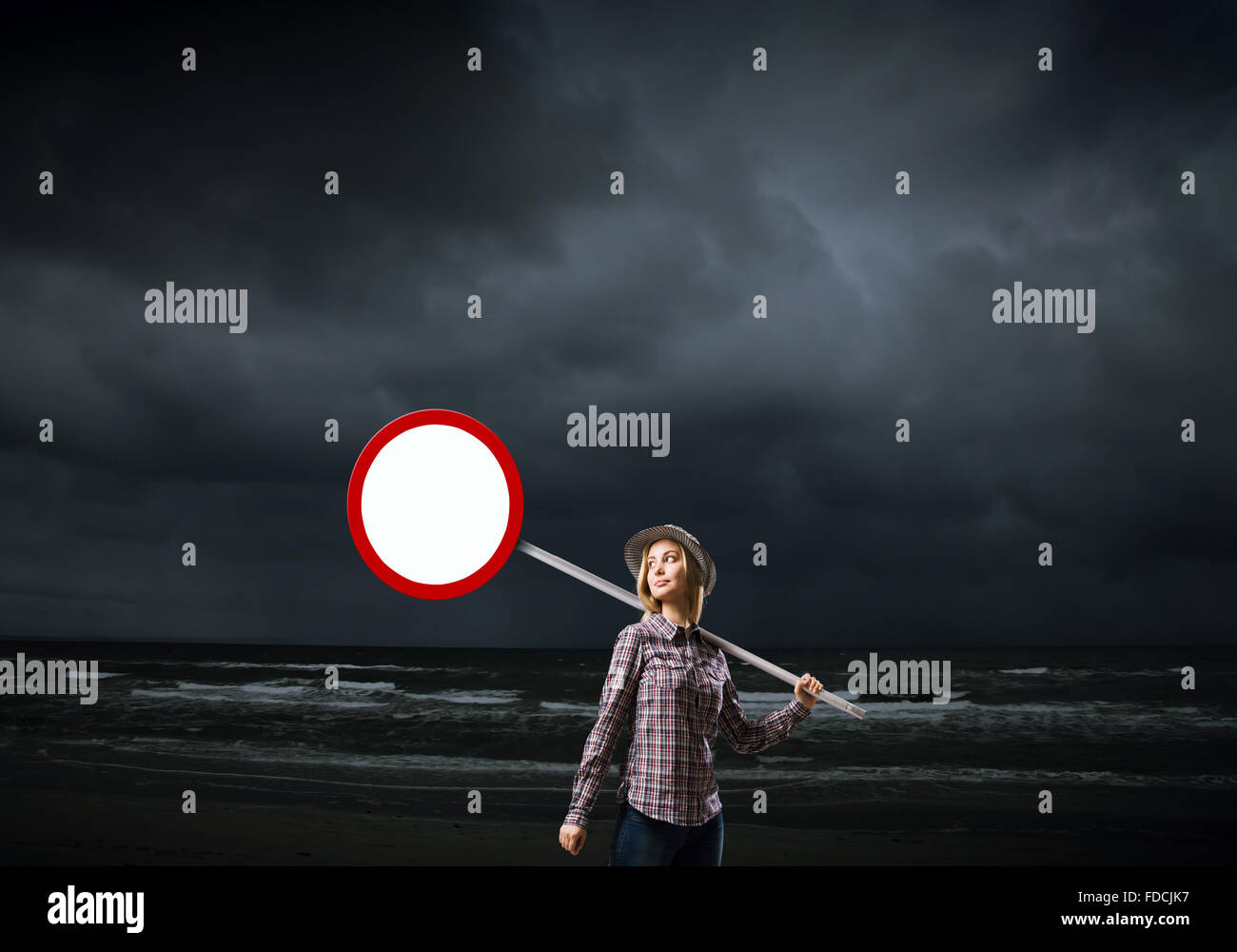Young girl in casual holding stop sign Stock Photo - Alamy