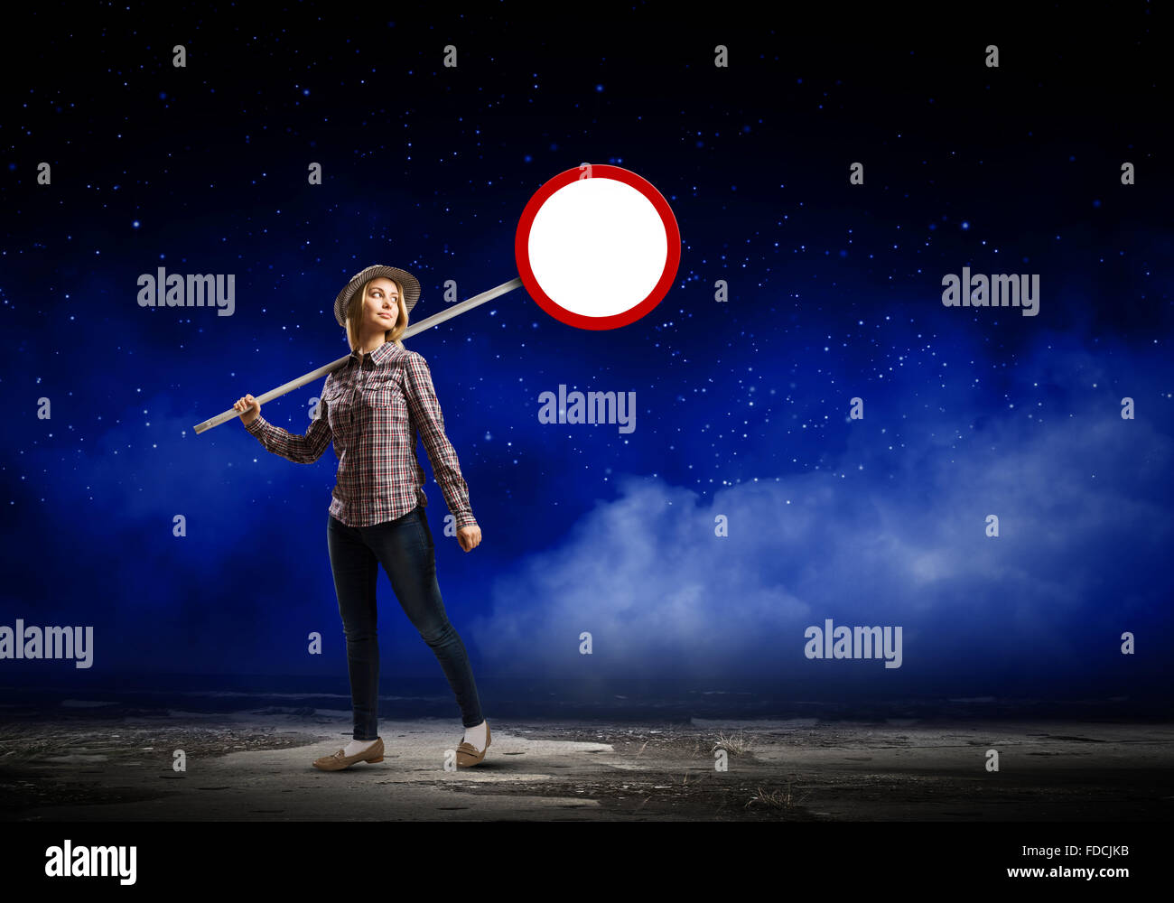 Young girl in casual holding stop sign Stock Photo - Alamy