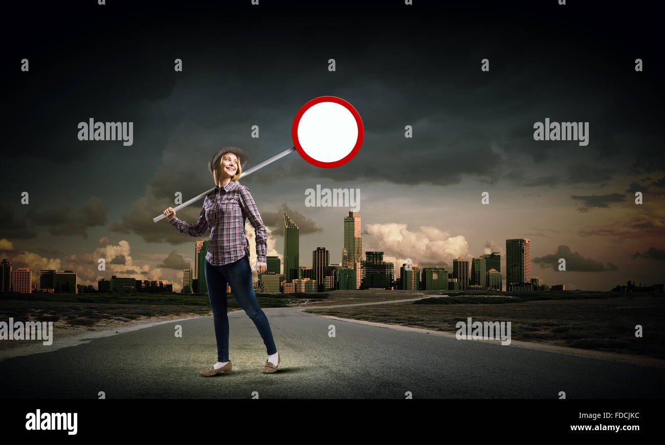 Young girl in casual holding stop sign Stock Photo - Alamy