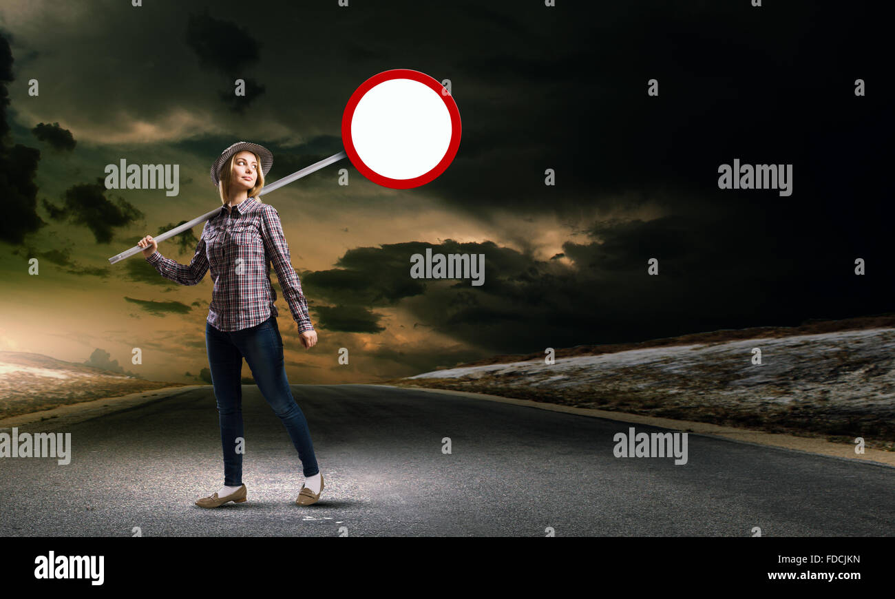 Young girl in casual holding stop sign Stock Photo - Alamy