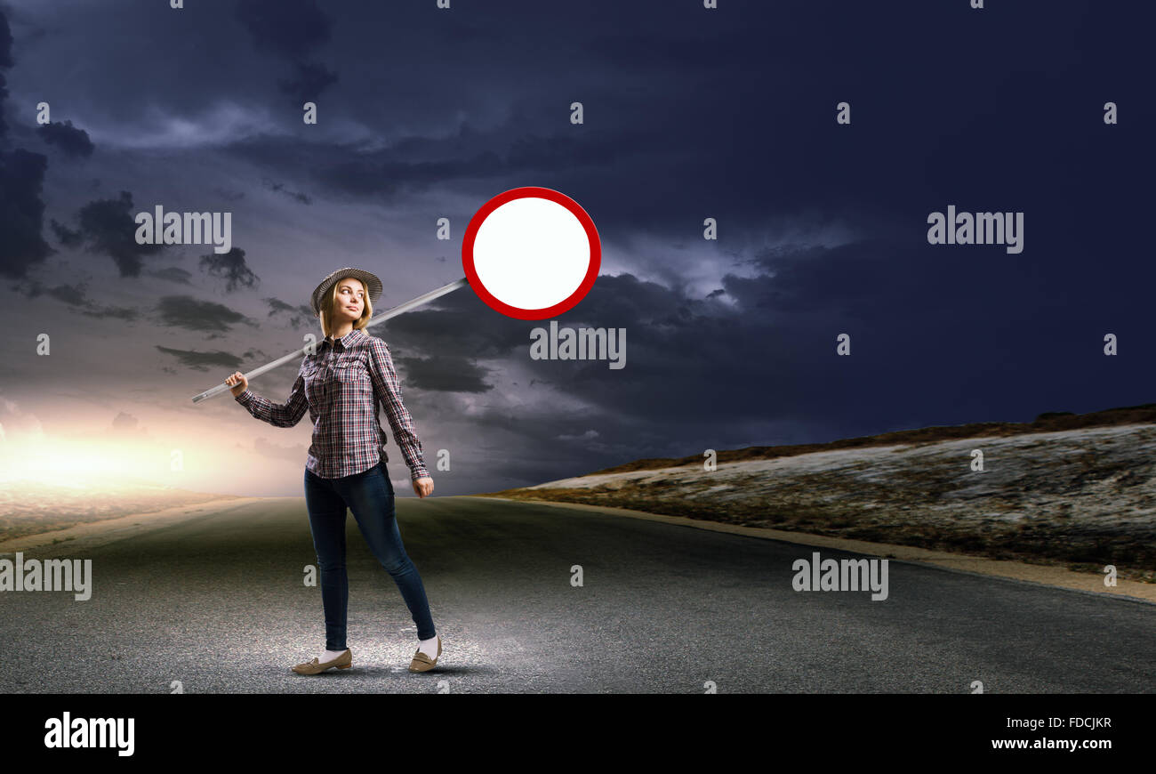 Young girl in casual holding stop sign Stock Photo - Alamy