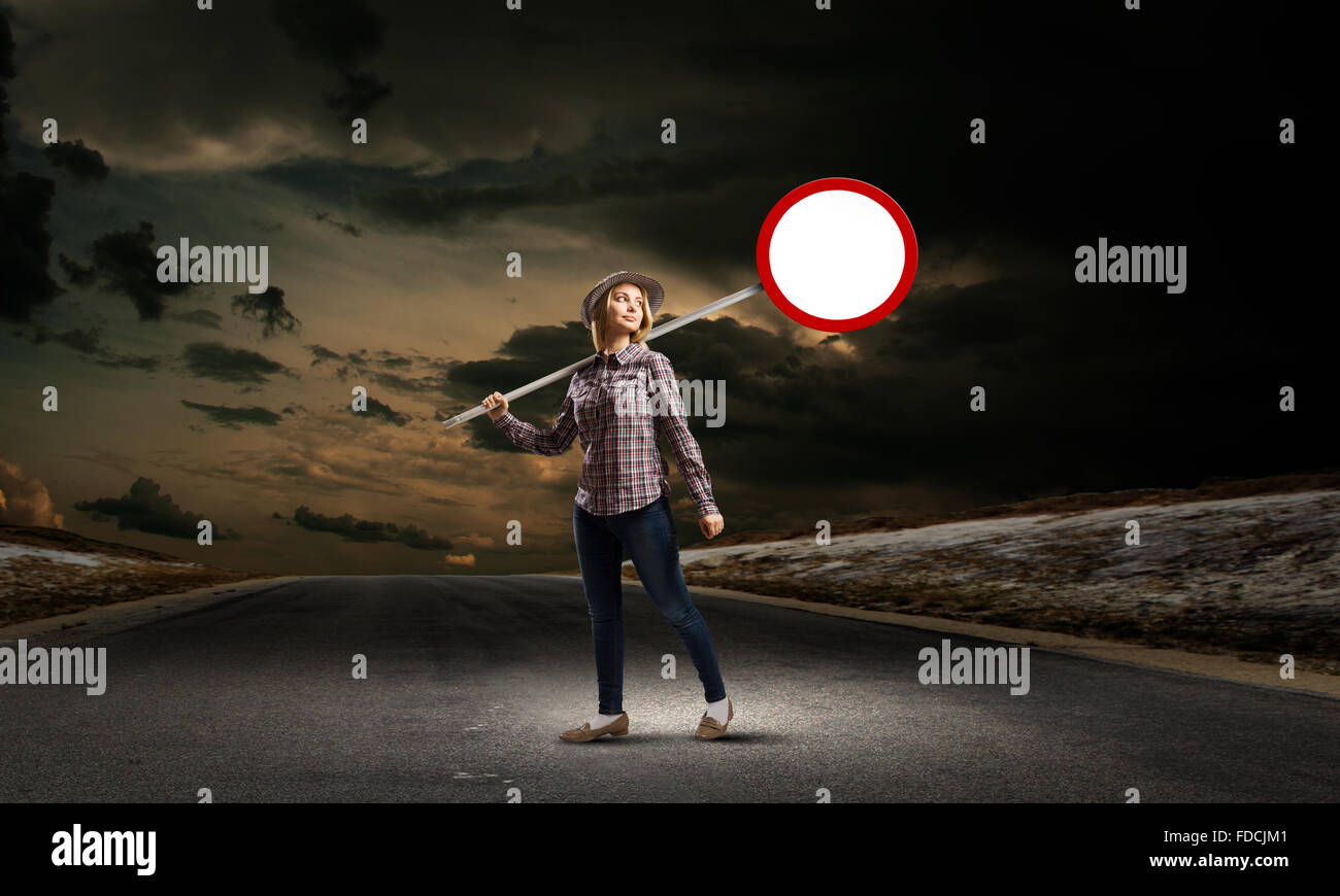 Young girl in casual holding stop sign Stock Photo - Alamy