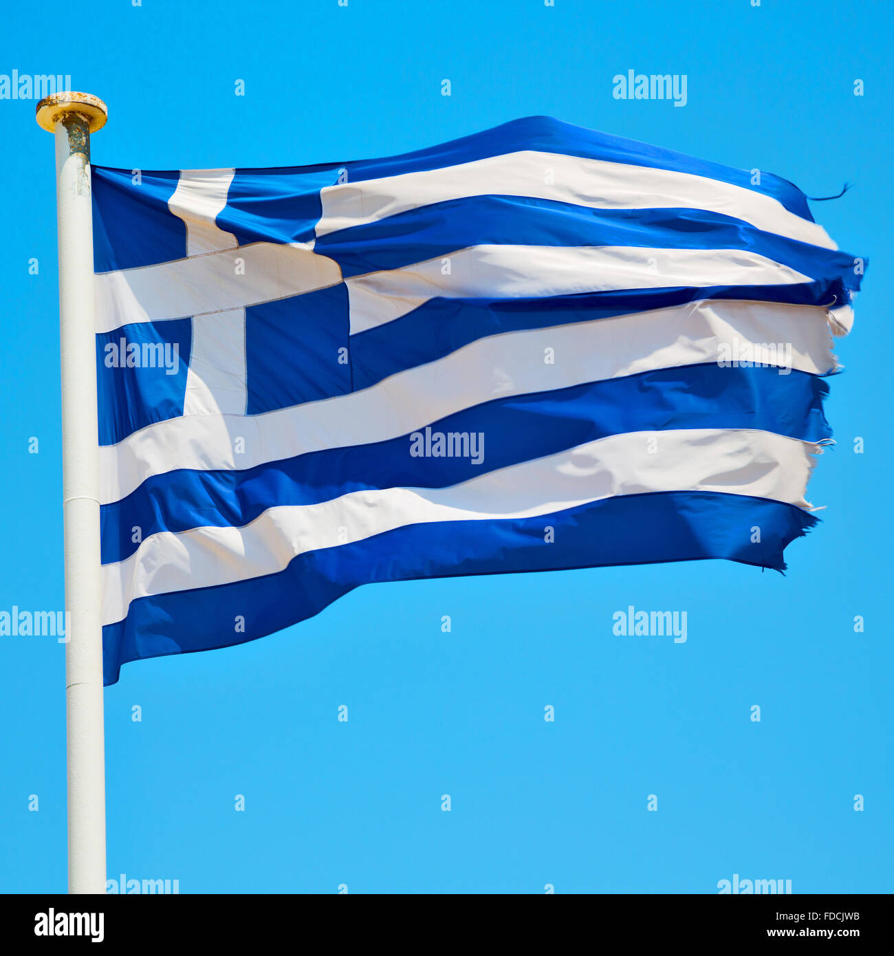 waving greece flag in the blue sky and flagpole Stock Photo - Alamy