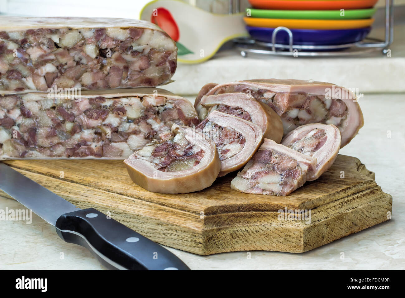 On the kitchen blackboard is sliced pig's stomach, stuffed with meat ...