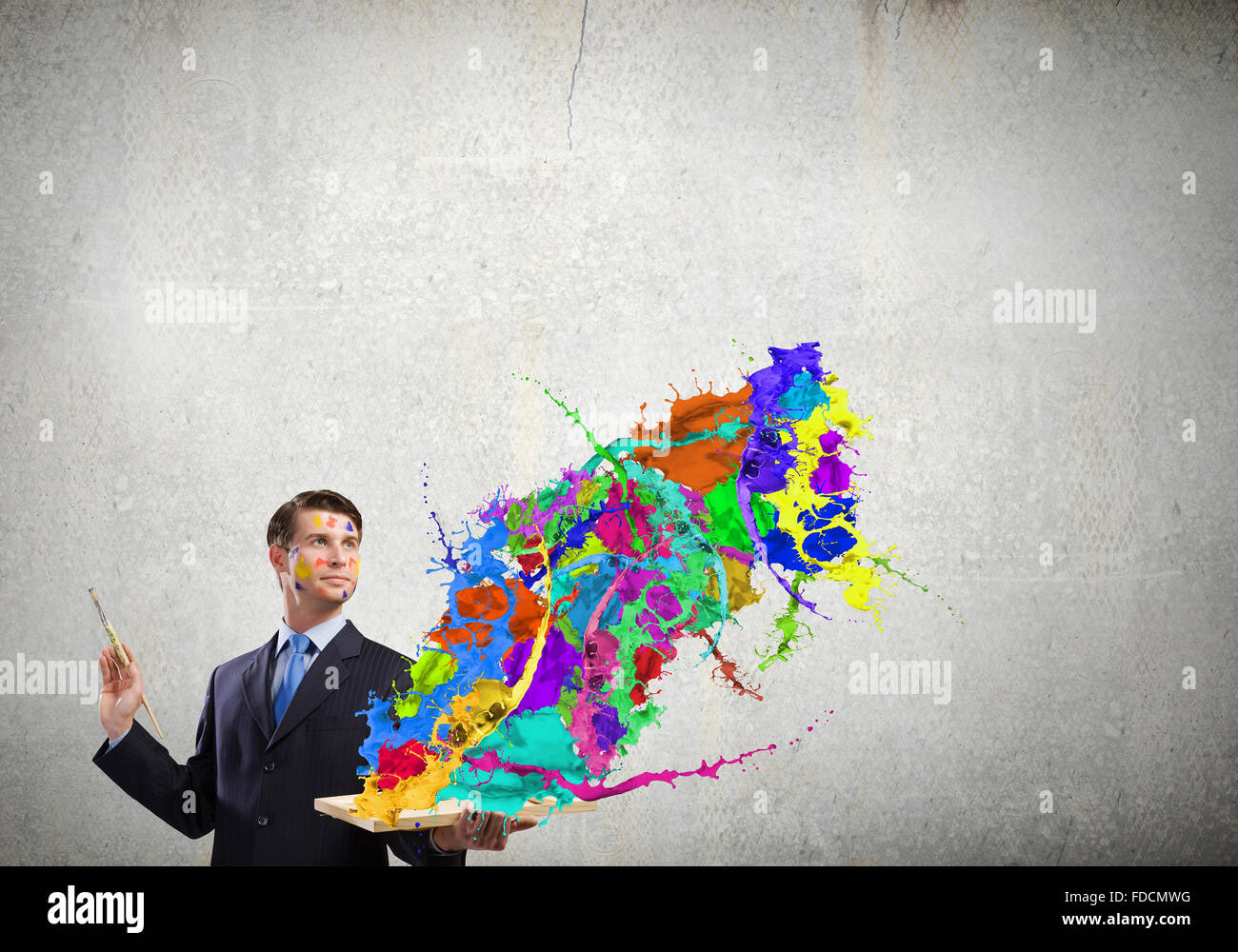 Young businessman with brush in hand and colorful paint splashes Stock ...