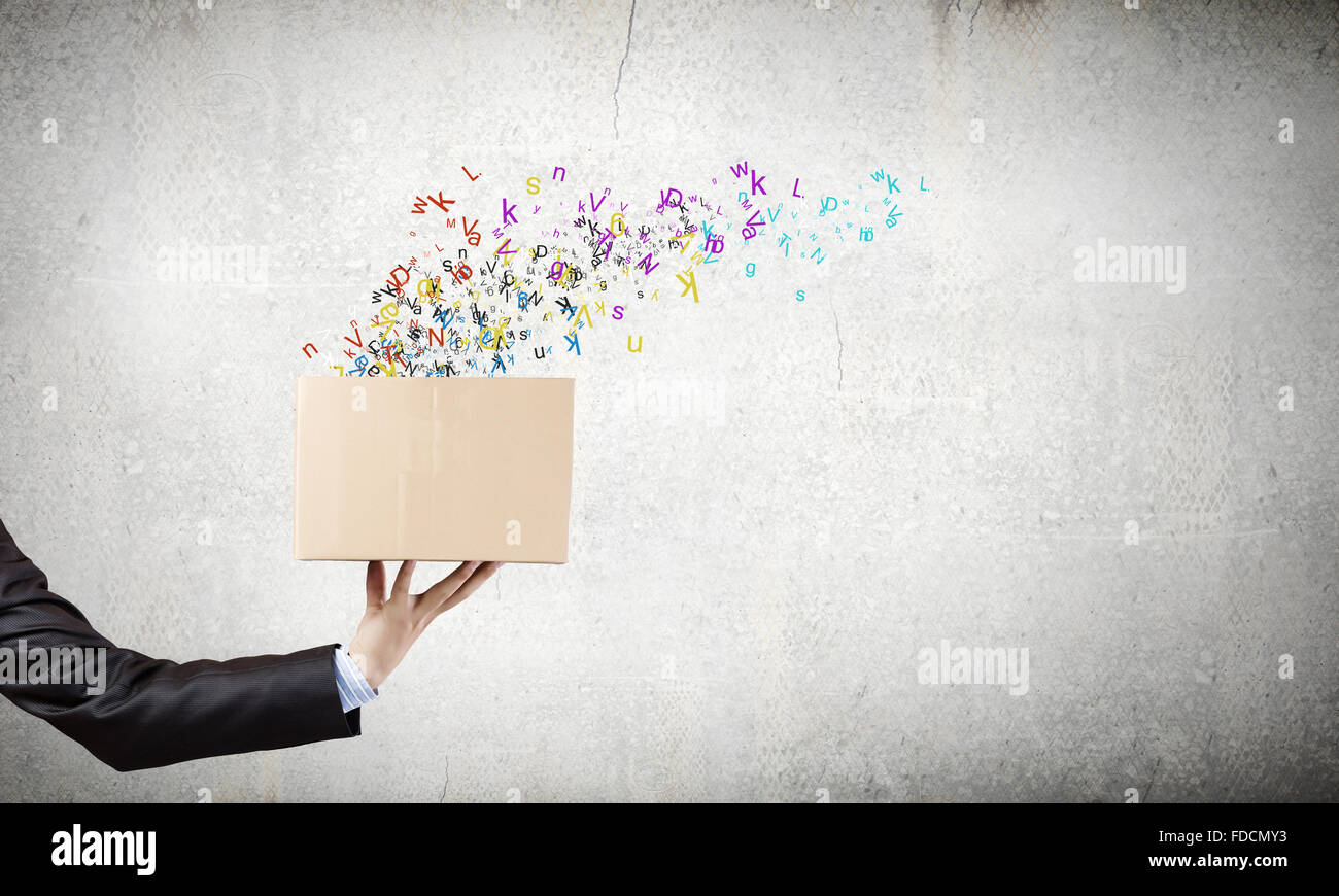 Close up of hand holding carton box with colorful letters Stock Photo ...