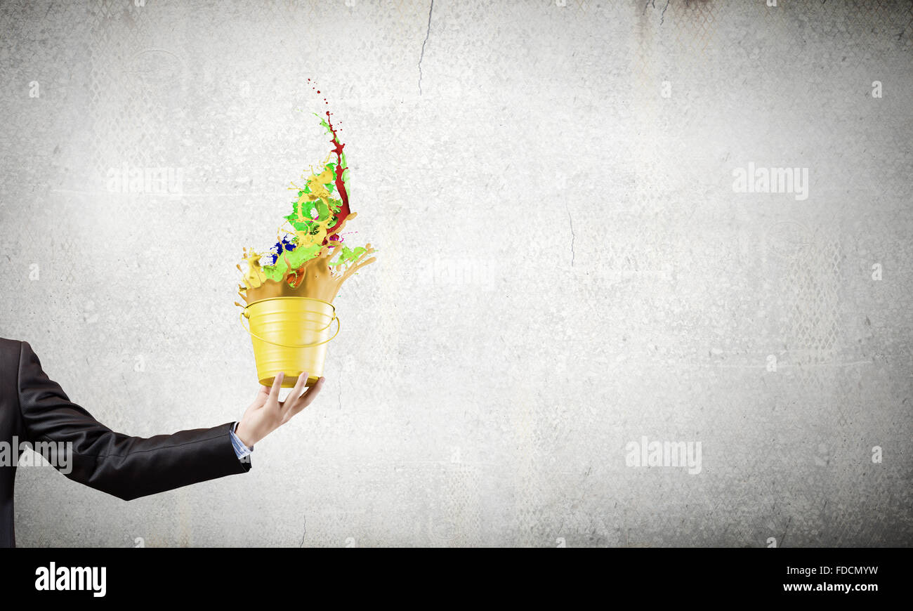 Close up of businessman hand holding bucket with paint Stock Photo - Alamy