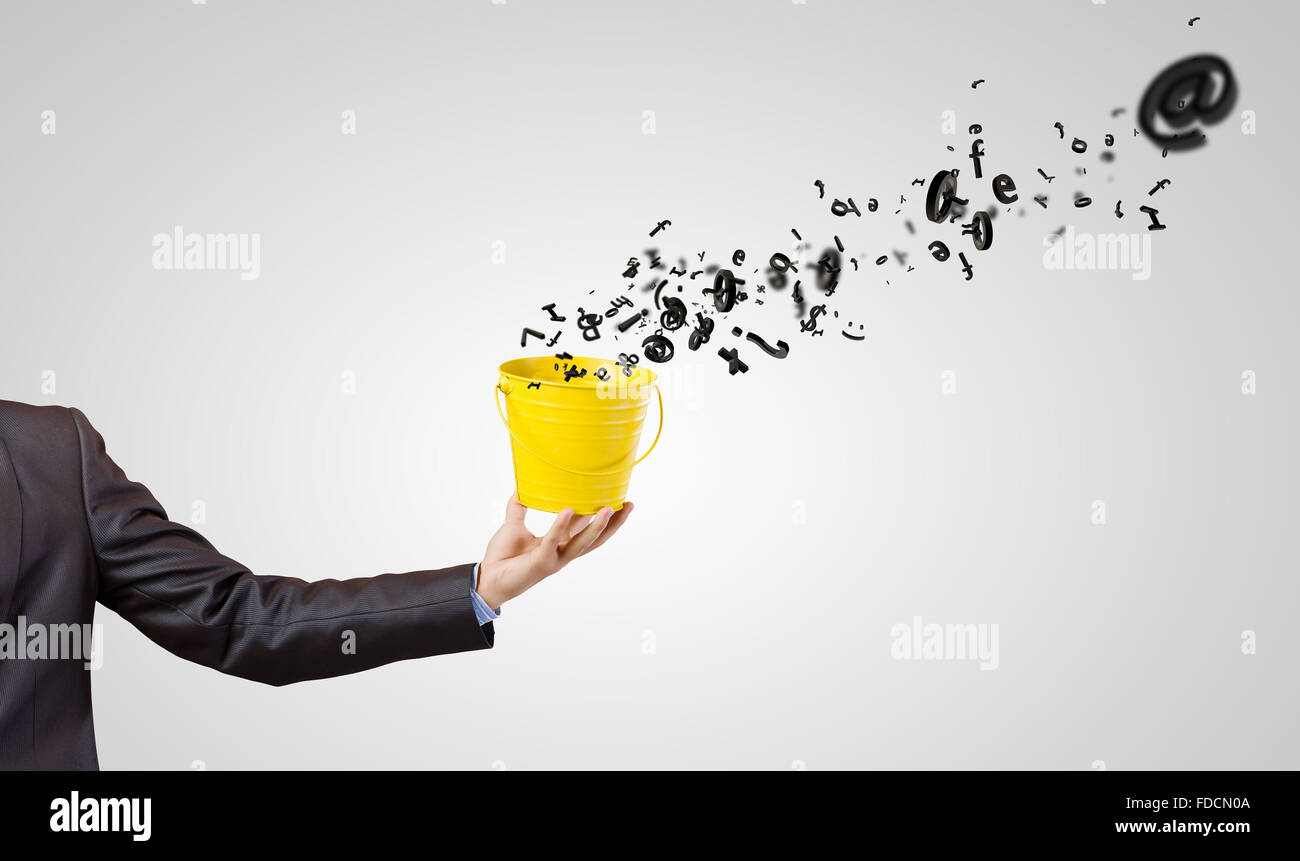 Close up of hand holding yellow bucket with letters Stock Photo - Alamy