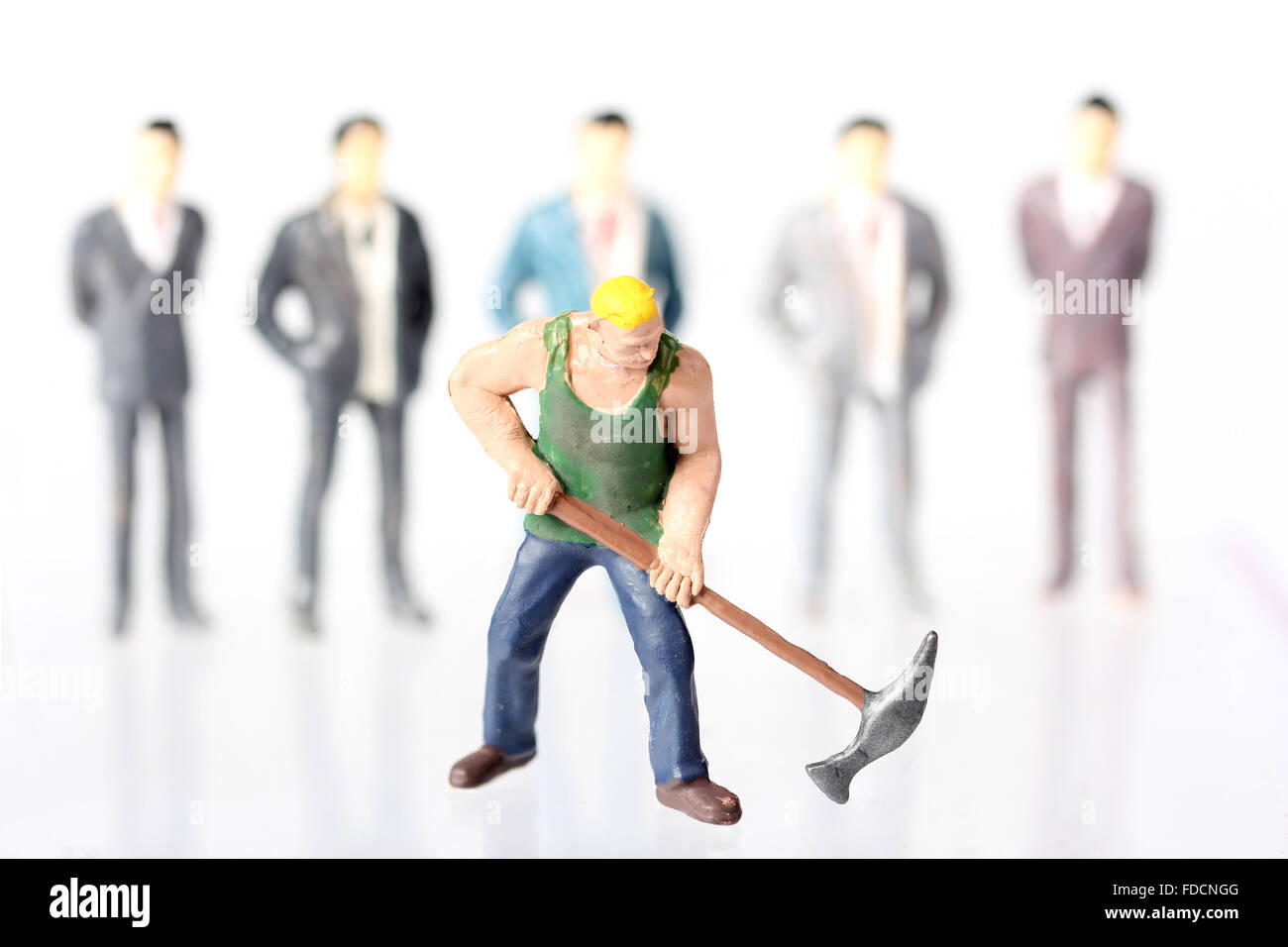 Miniature figurines of One worker and many White collar businessmen ...
