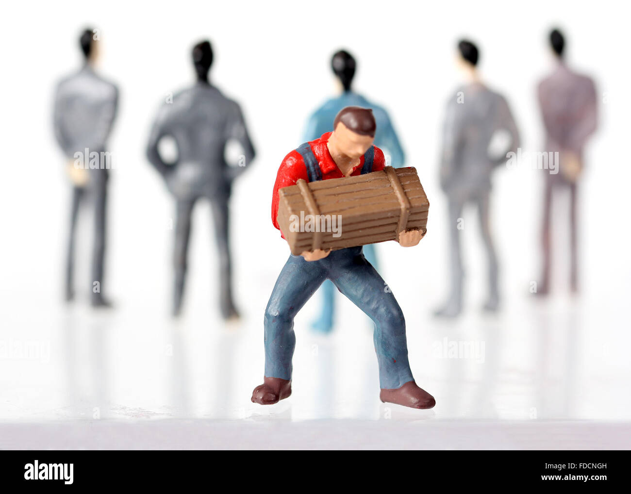 Miniature figurines of One worker and many White collar businessmen ...