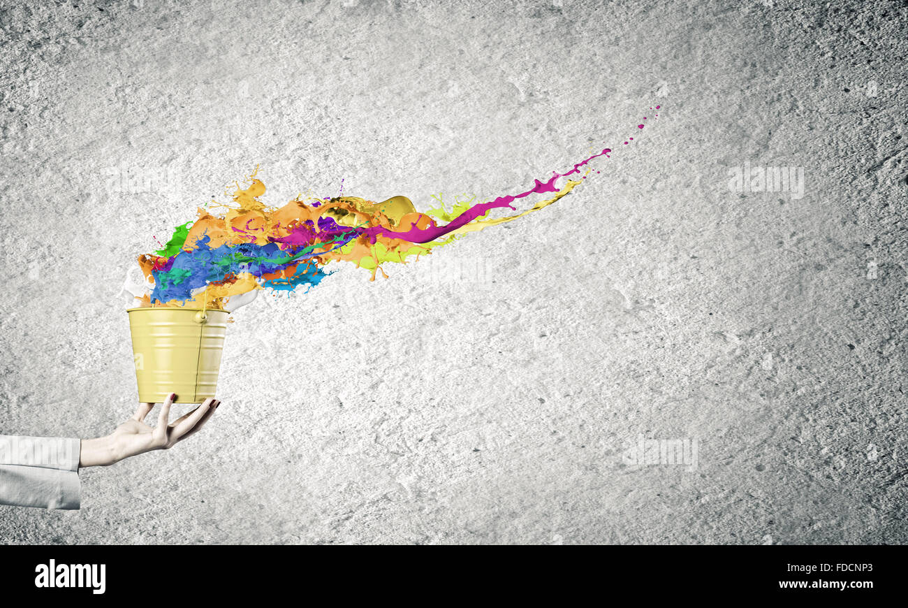 Close up of businesswoman holding bucket with paint splashes Stock ...