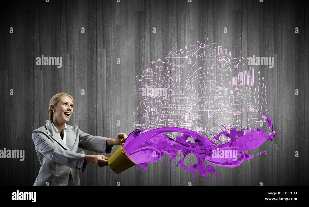 Young businesswoman holding bucket with paint splashes Stock Photo - Alamy