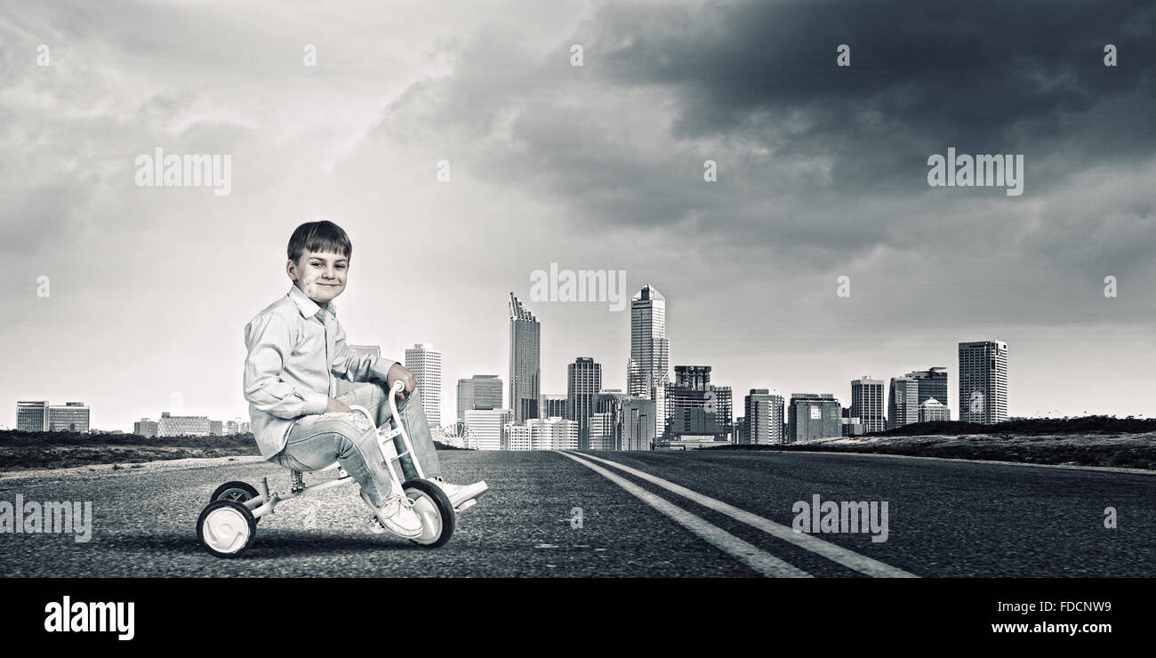 Little joyful cute boy riding tricycle on road Stock Photo - Alamy