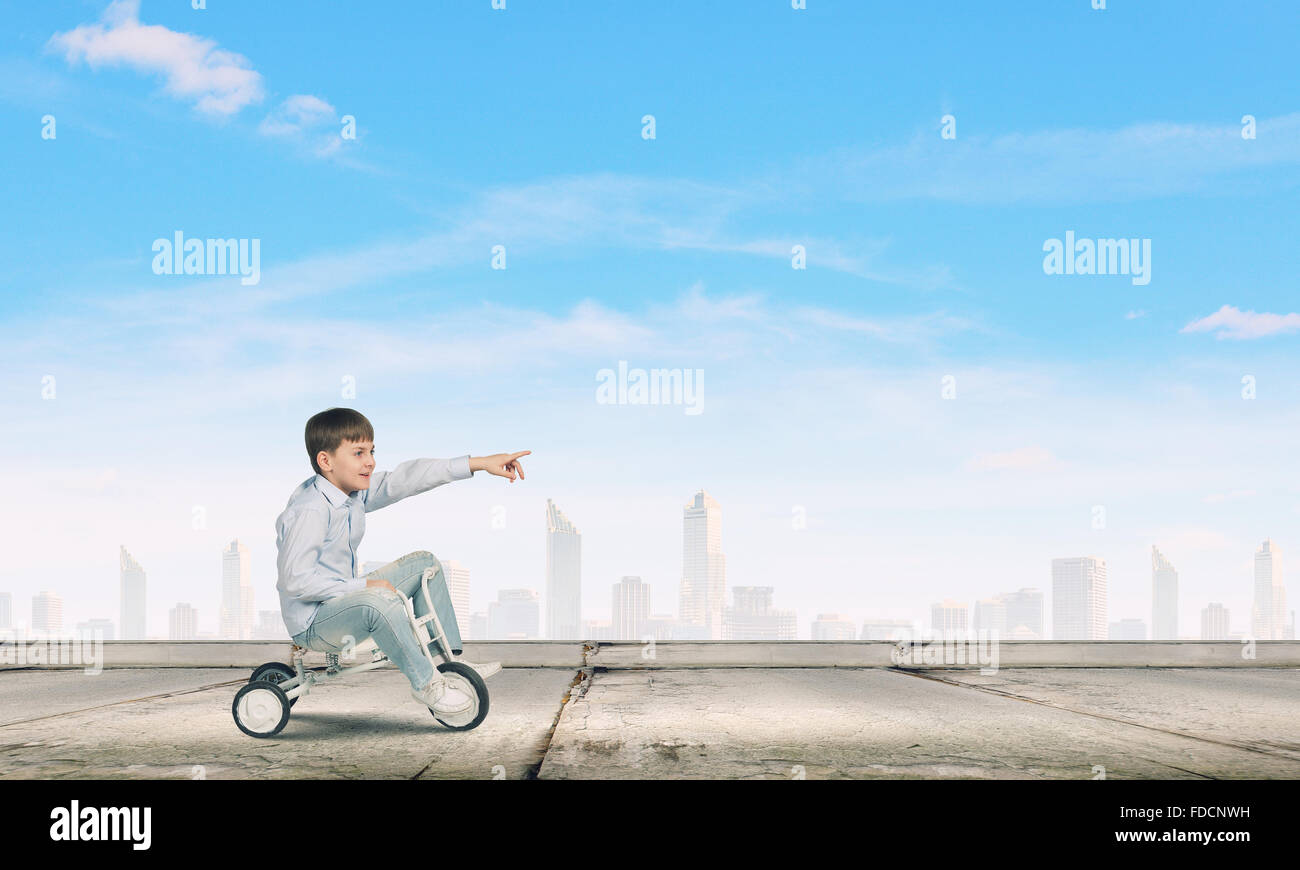 Little joyful cute boy riding tricycle on road Stock Photo - Alamy