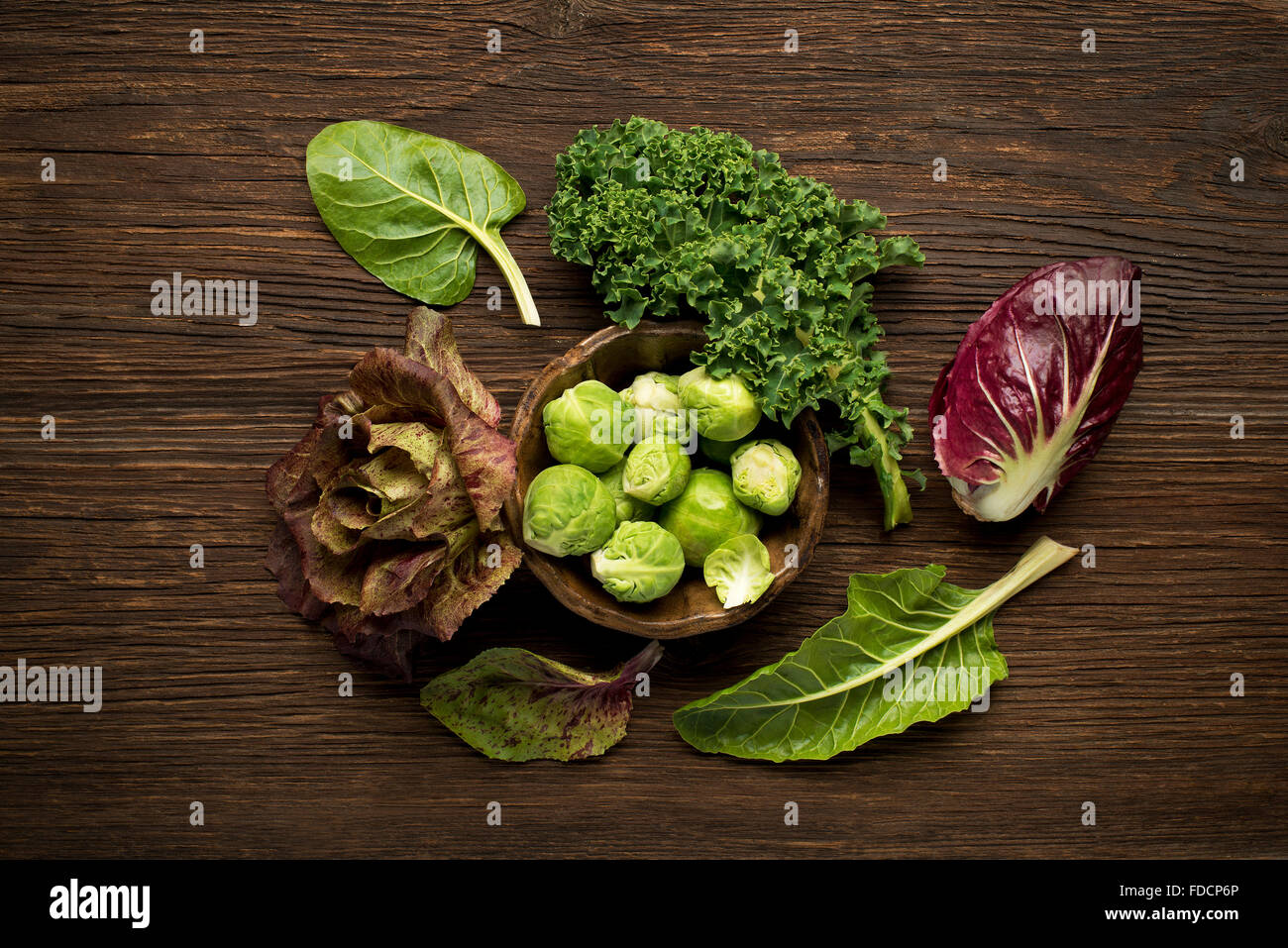 Brussels sprouts, kale, chard and radicchio vegetables on wooden ...