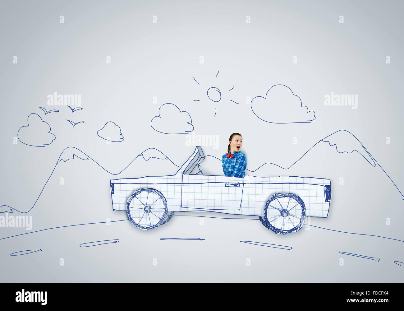 Young girl driving car made of paper Stock Photo - Alamy