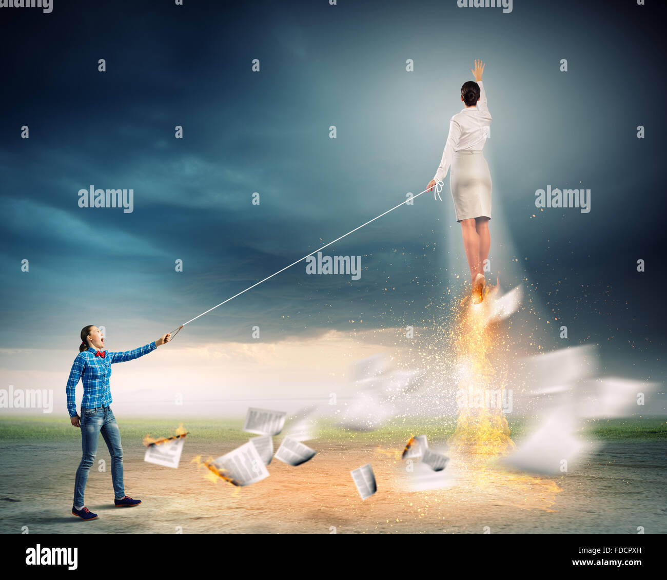 Businesswoman on lead trying to fly away Stock Photo - Alamy