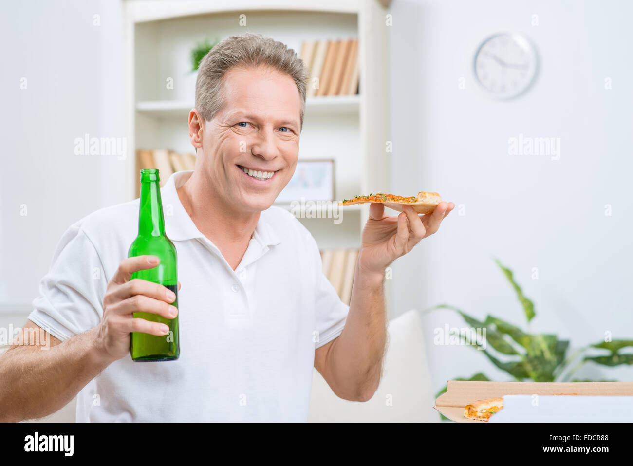 Content adult man drinking beer Stock Photo - Alamy