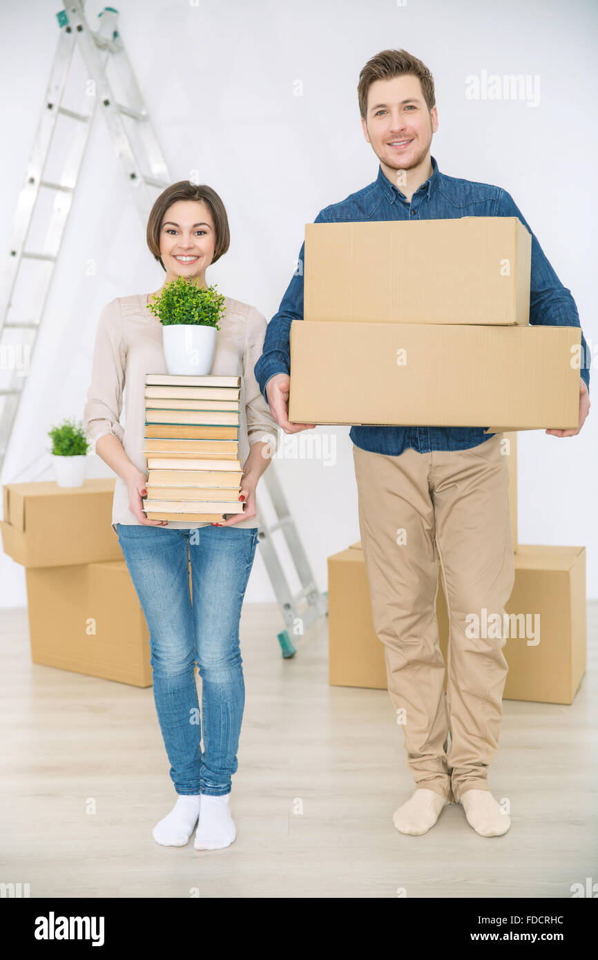 Happy couple holding boxes Stock Photo - Alamy