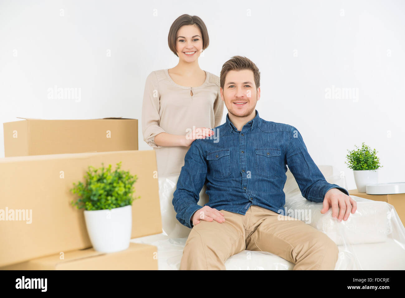 Cheerful couple resting on the sofa Stock Photo - Alamy