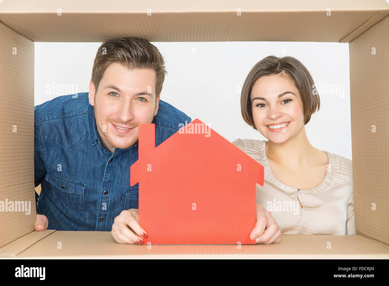 Overjoyed couple looking through the box Stock Photo - Alamy