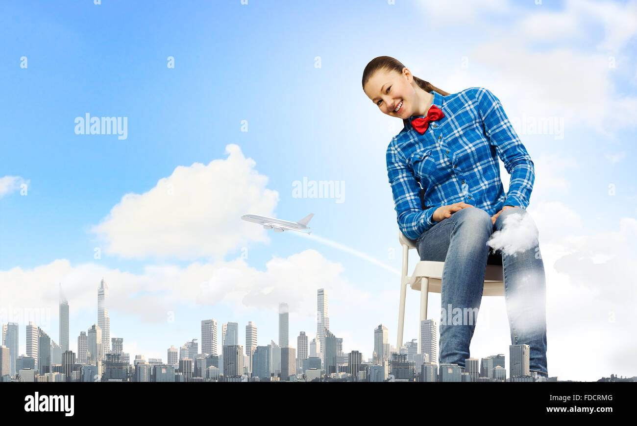 Young giant woman sitting on chair above modern city Stock Photo - Alamy