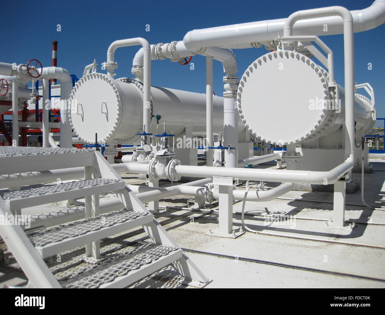 Heat exchangers in a refinery Stock Photo - Alamy