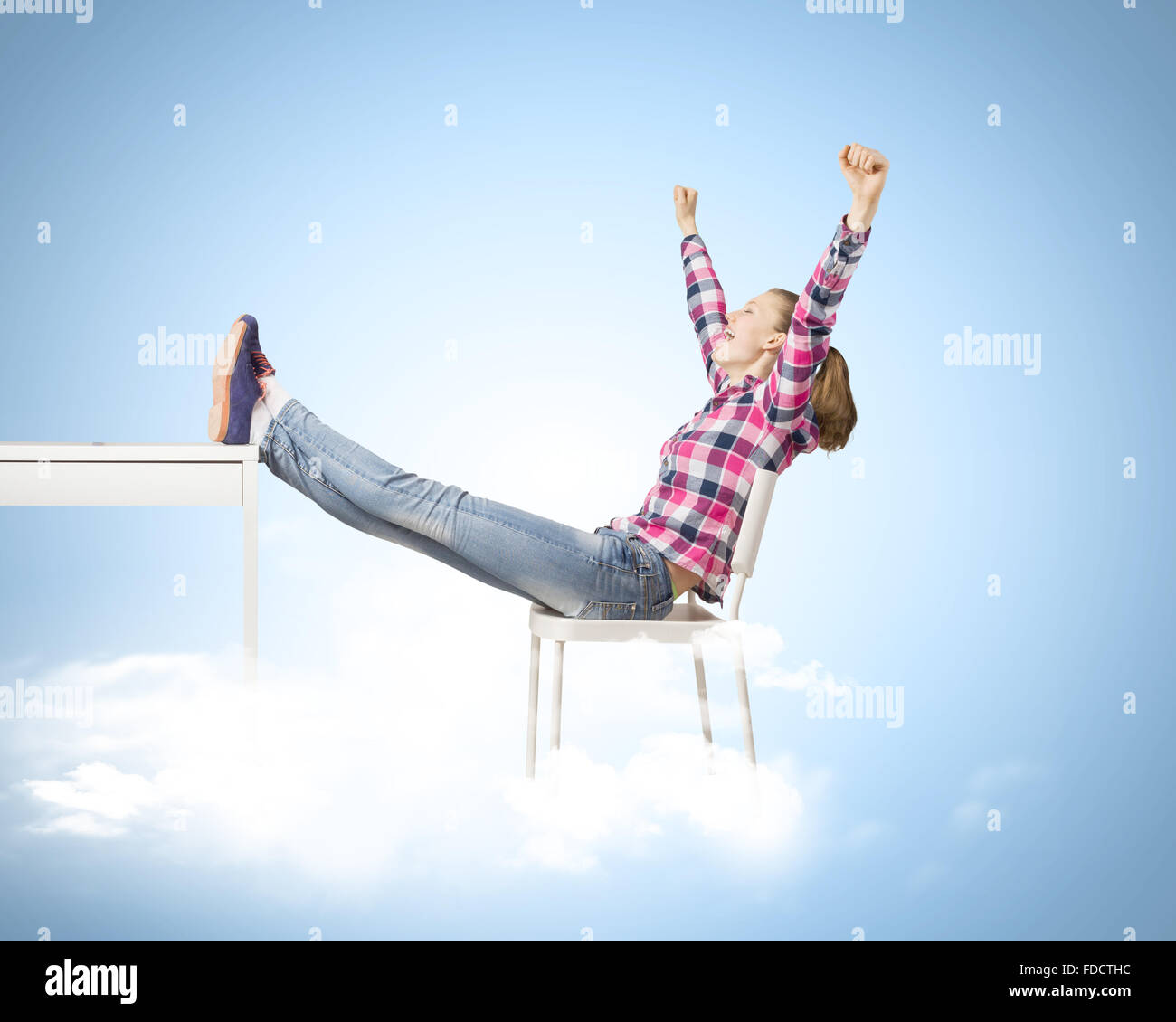 Young woman in casual with arms up celebrating success Stock Photo - Alamy