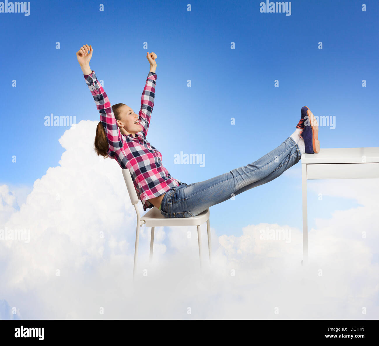 Young woman in casual with arms up celebrating success Stock Photo - Alamy