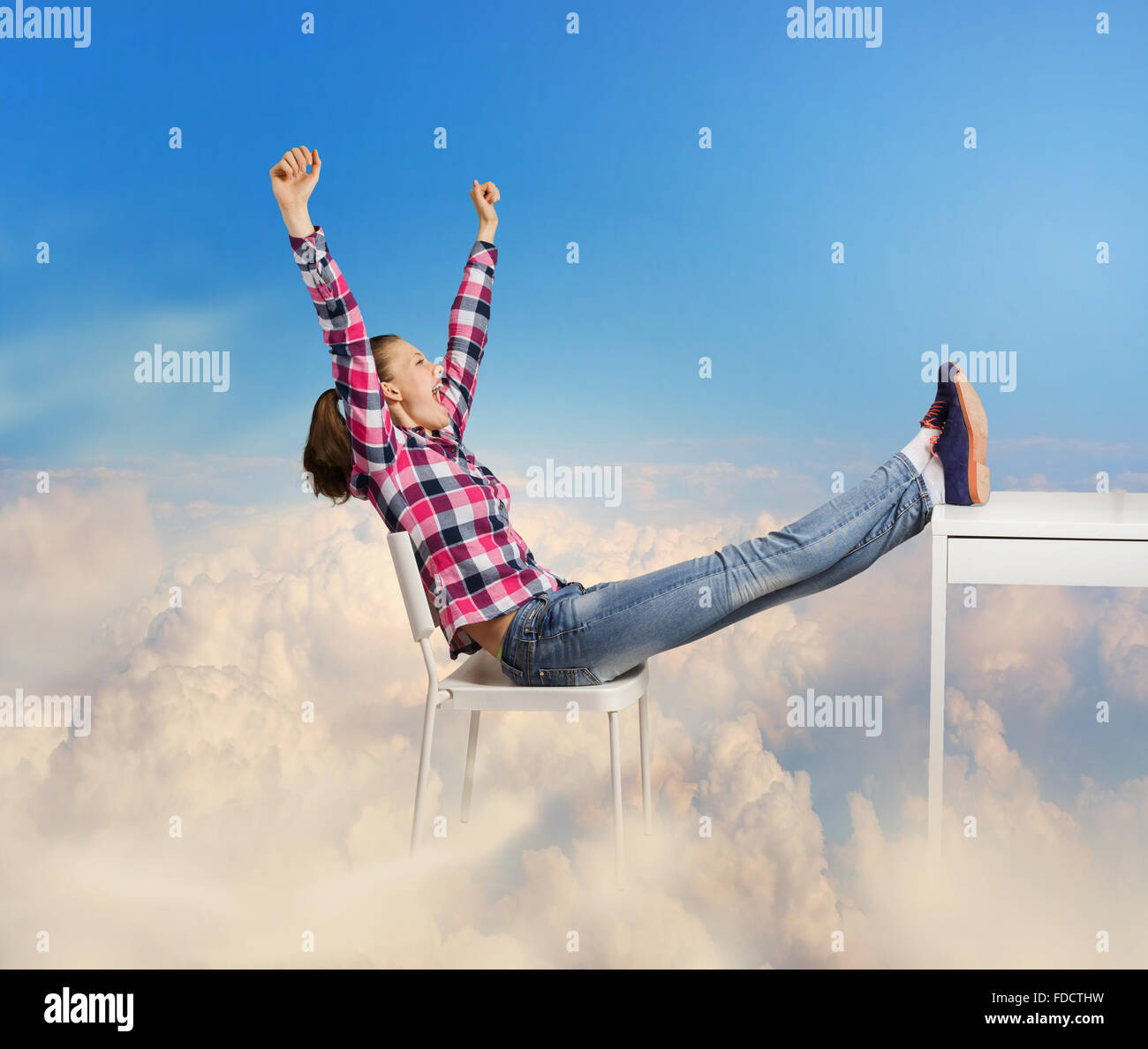 Young woman in casual with arms up celebrating success Stock Photo - Alamy