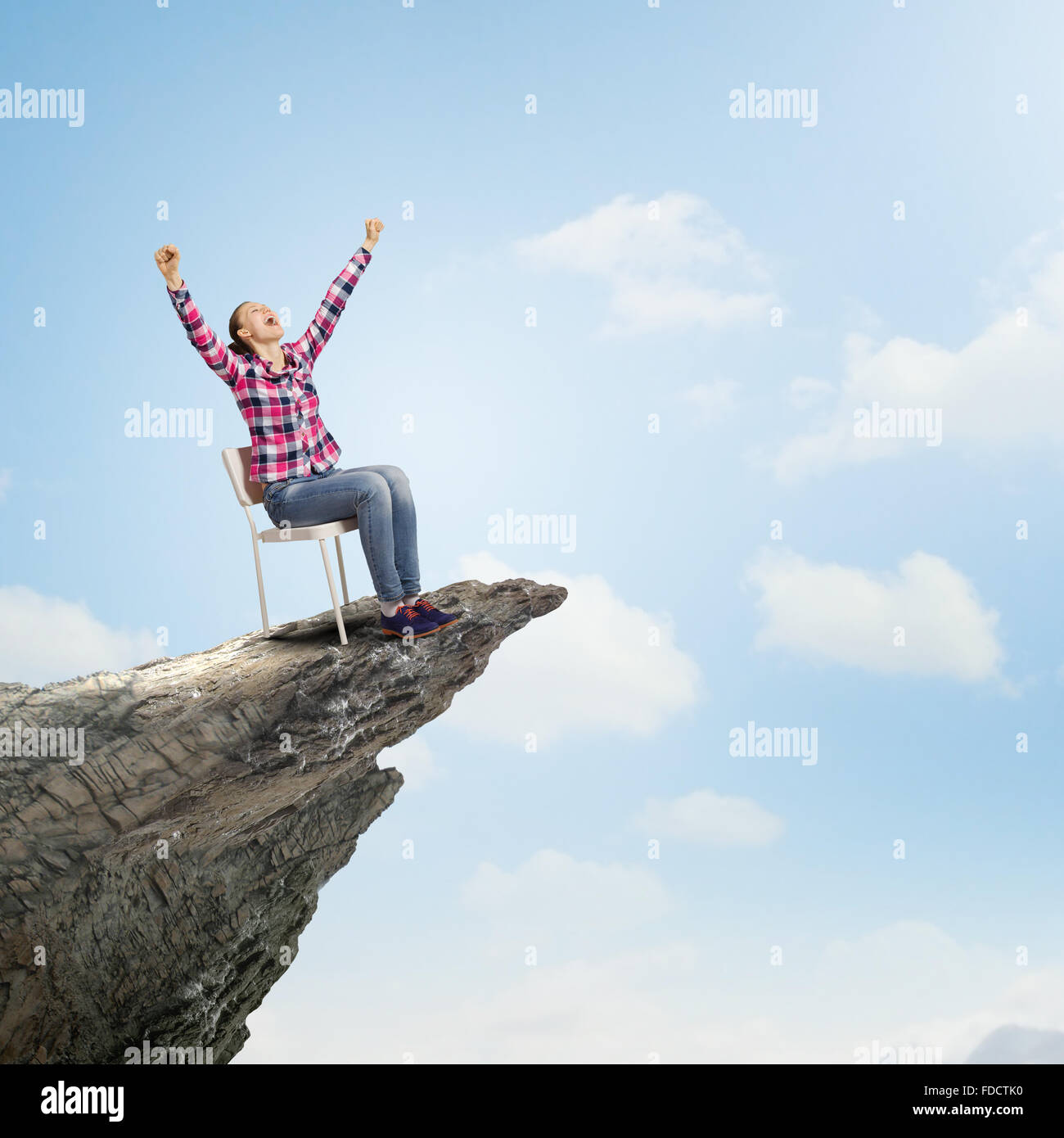 Young woman in casual with arms up celebrating success Stock Photo - Alamy