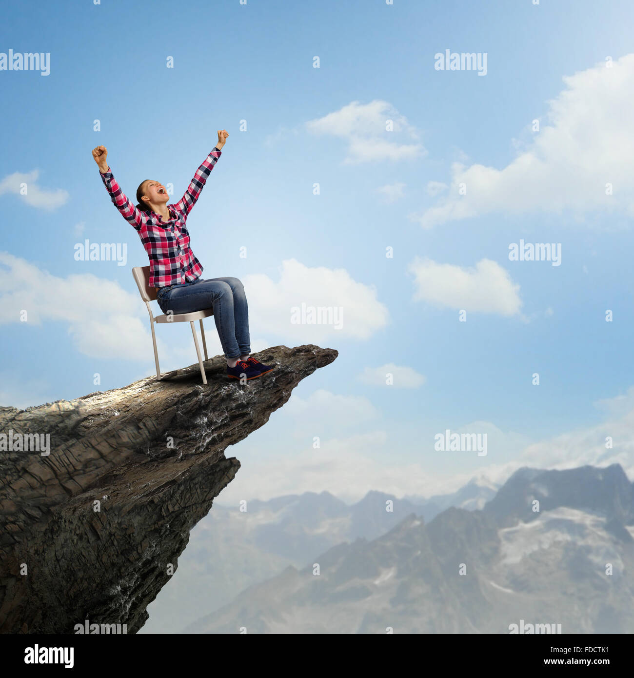 Young woman in casual with arms up celebrating success Stock Photo - Alamy