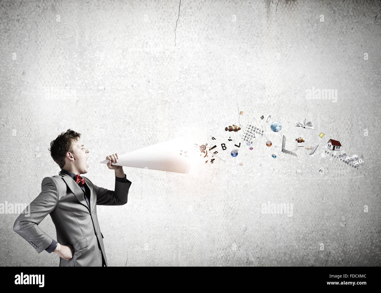 Young businessman screaming emotionally in paper trumpet Stock Photo ...