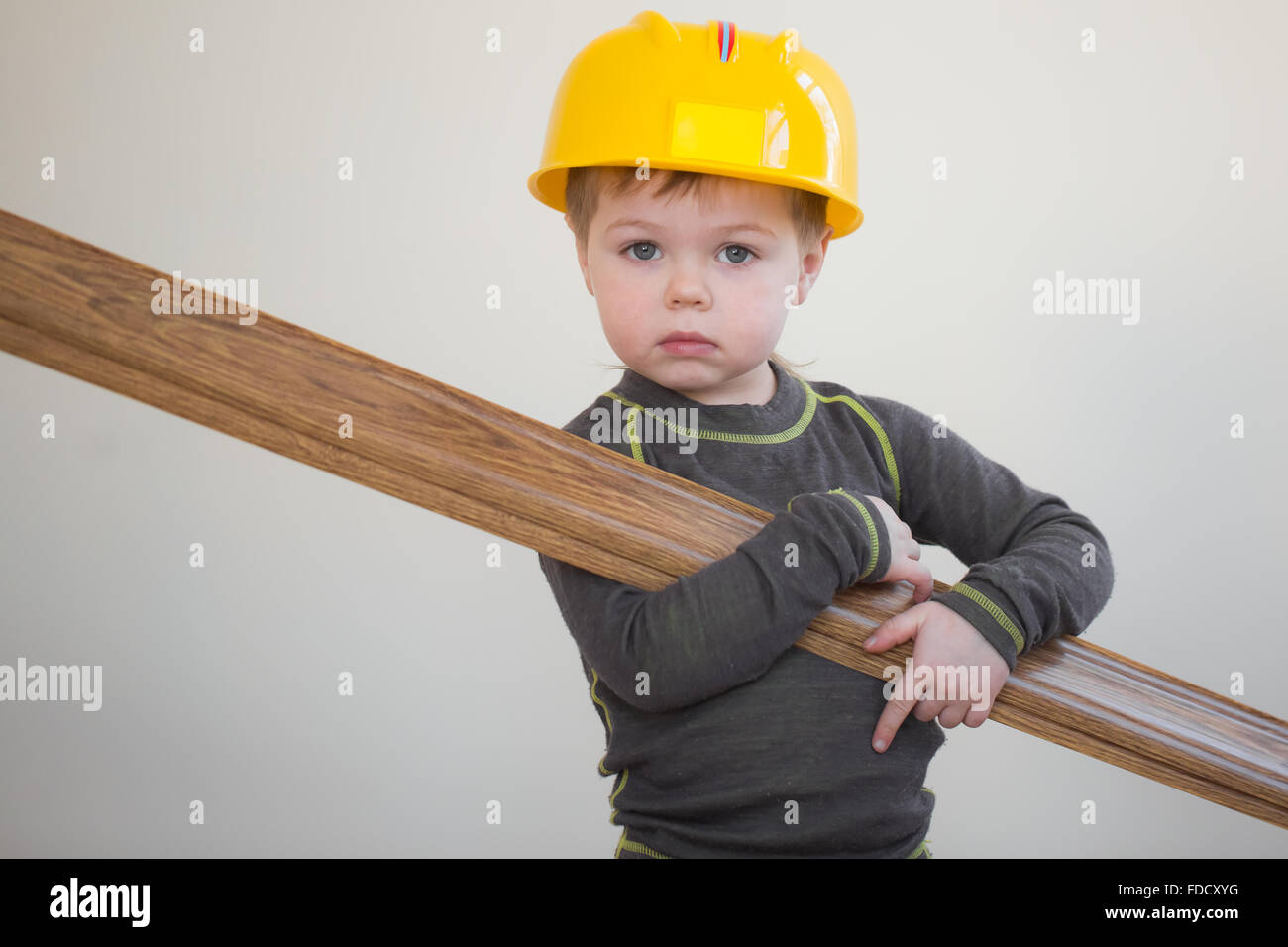 boy in protective helmet keaping plinth in his hands Stock Photo - Alamy