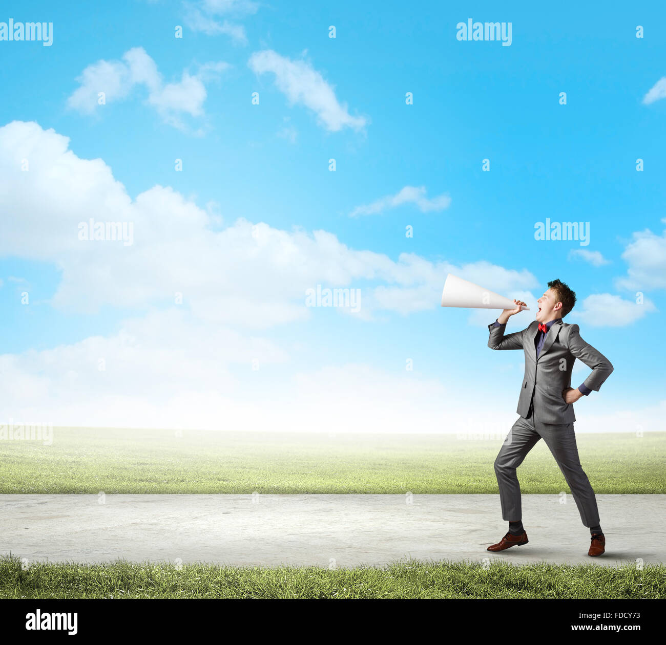Young businessman screaming emotionally in paper trumpet Stock Photo ...