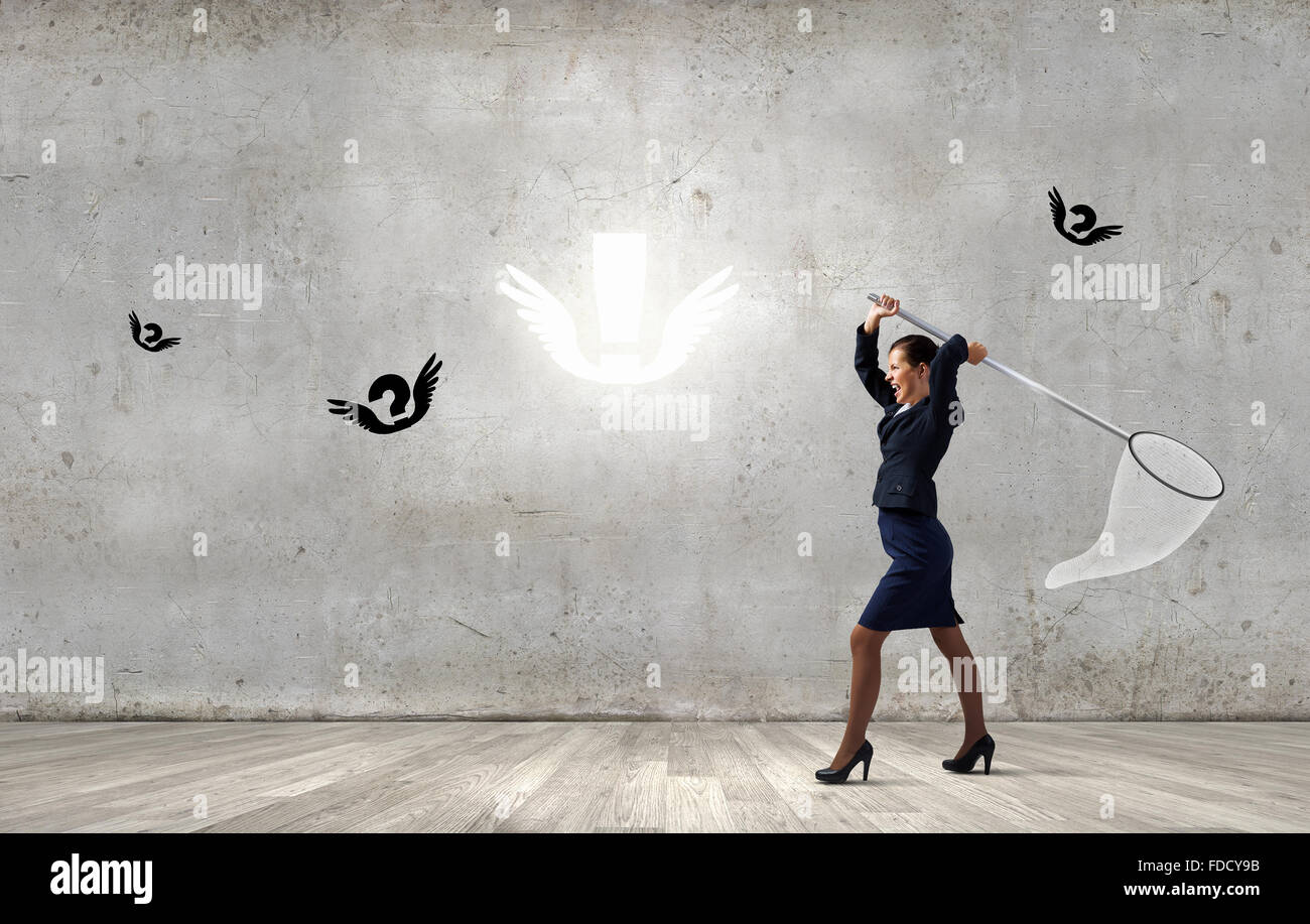 Young businesswoman catching flying marks with hoop Stock Photo - Alamy