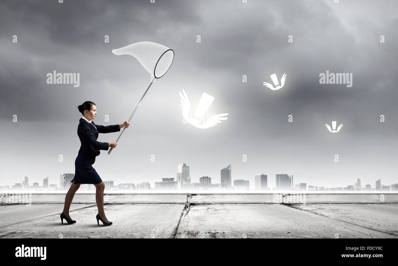 Young businesswoman catching flying marks with hoop Stock Photo - Alamy