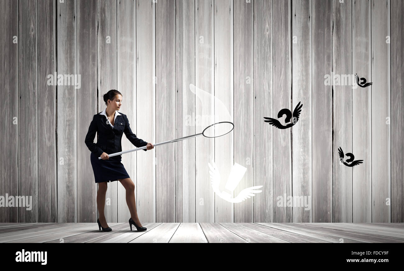 Young businesswoman catching flying marks with hoop Stock Photo - Alamy