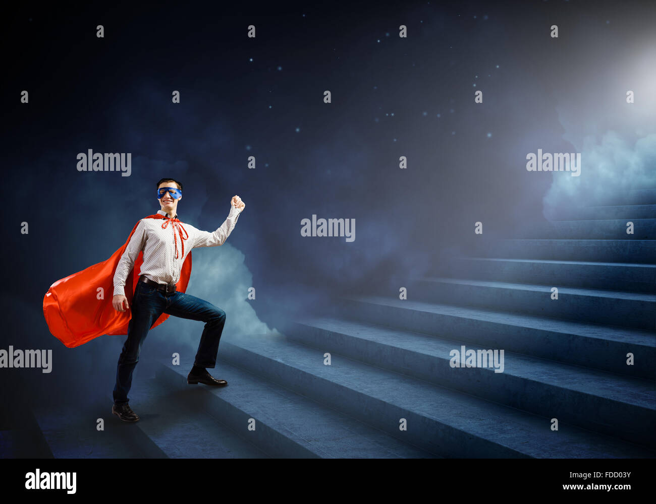 Young superman walking up the stair case Stock Photo - Alamy