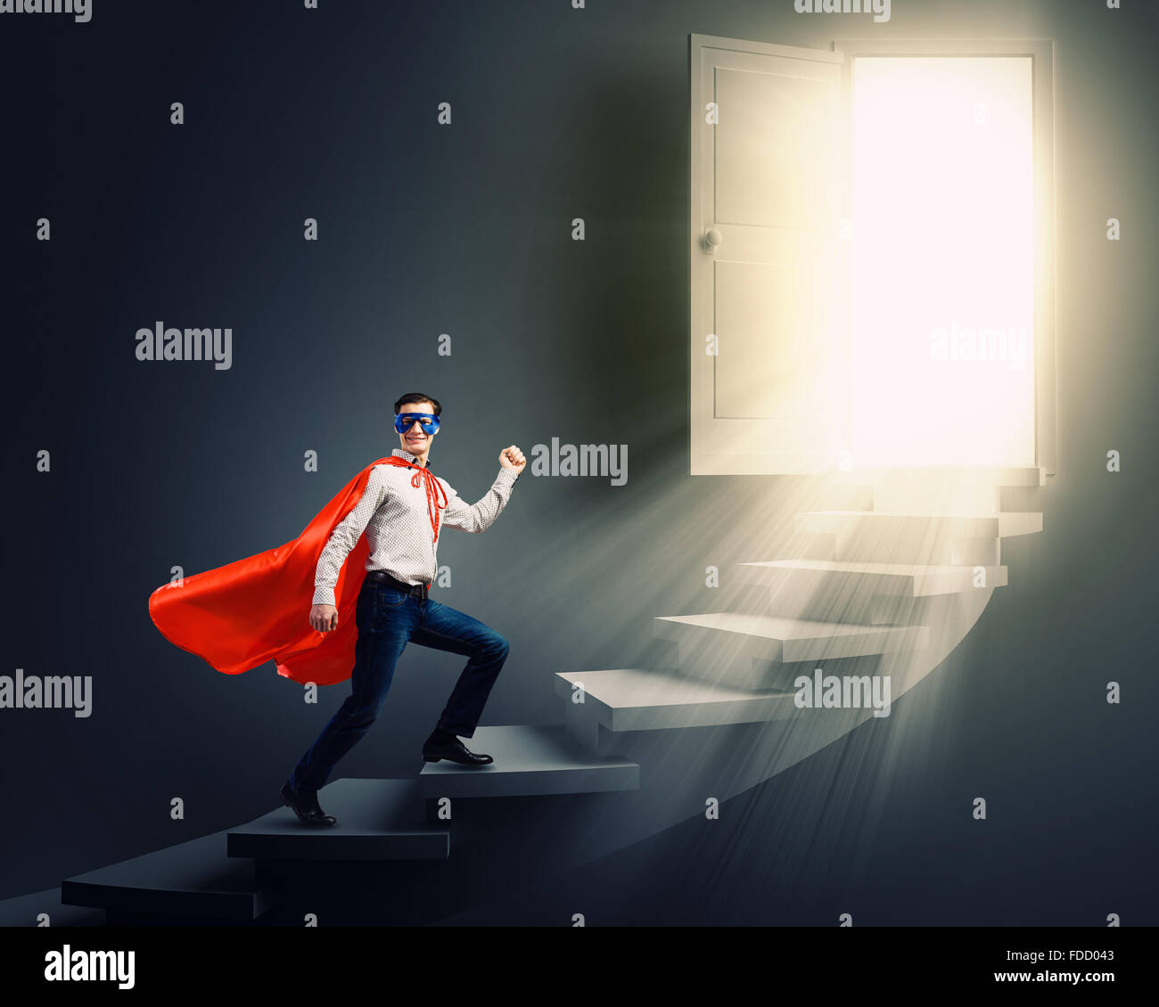 Young superman walking up the stair case Stock Photo - Alamy