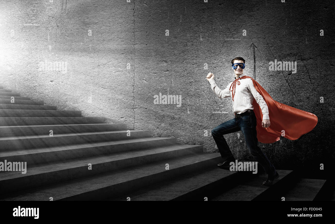 Young superman walking up stair hi-res stock photography and images - Alamy