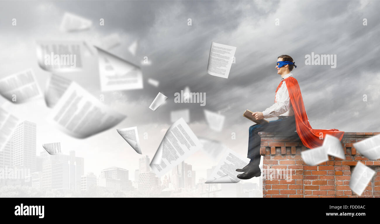 Superhero reading book hi-res stock photography and images - Alamy