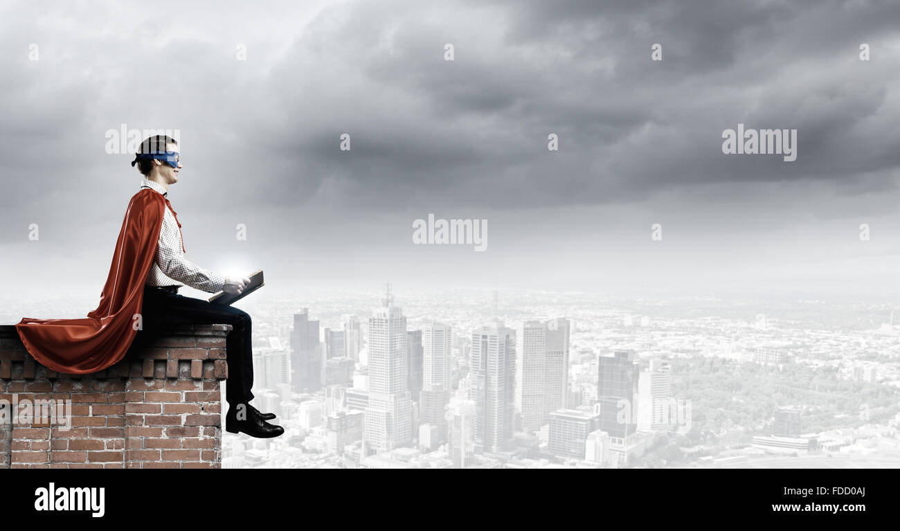 Superhero reading book hi-res stock photography and images - Alamy