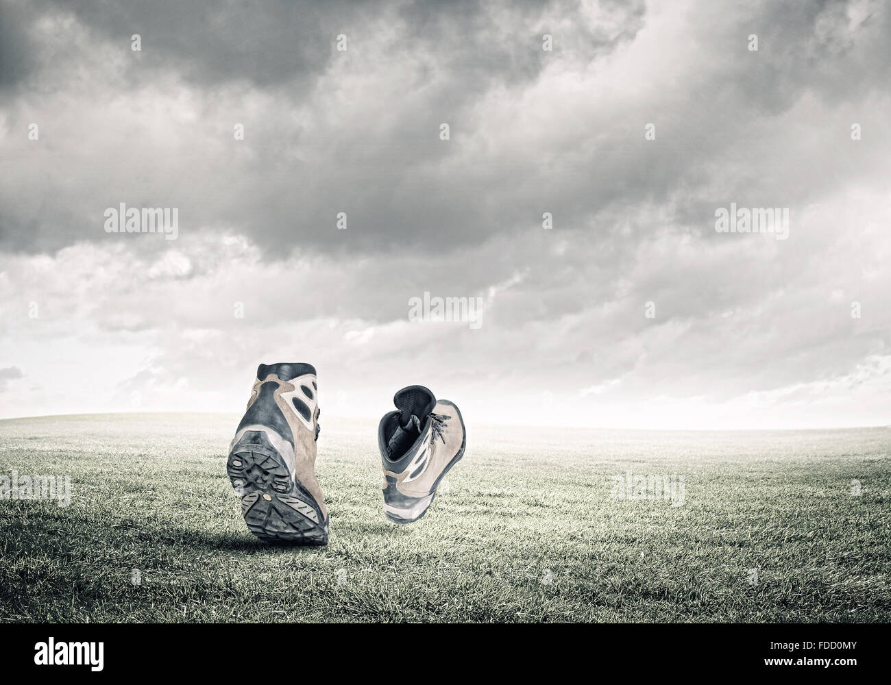 Pair of hikers boots walking on path Stock Photo - Alamy