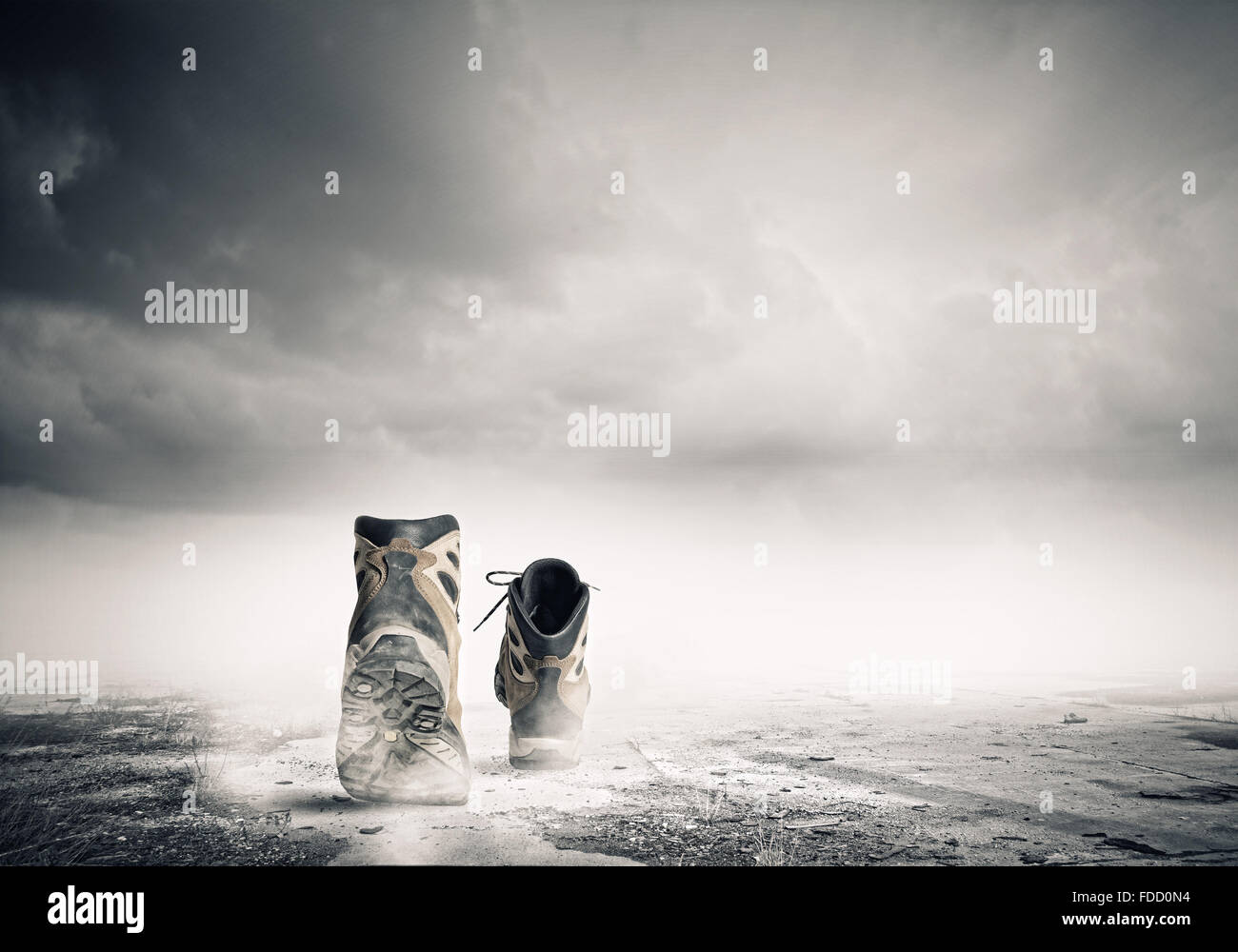 Pair of hikers boots walking on path Stock Photo - Alamy