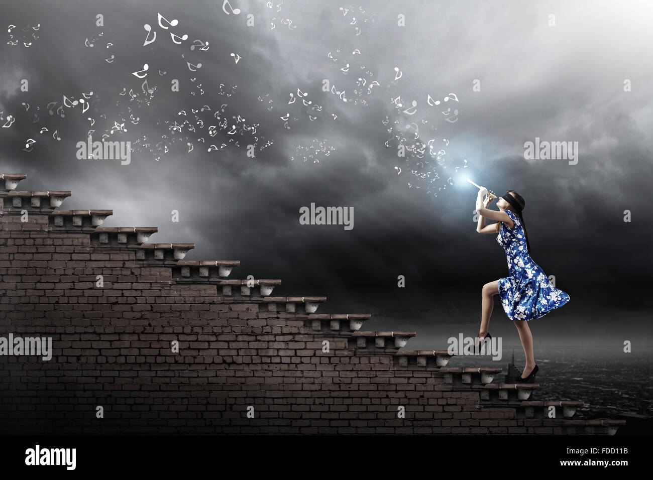 Young woman in blue dress wearing blindfold playing fife Stock Photo ...