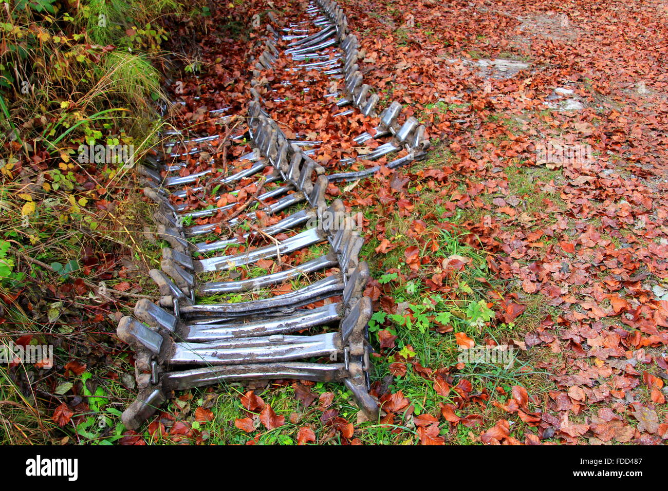 excavator chains in the forest on the ground Stock Photo - Alamy