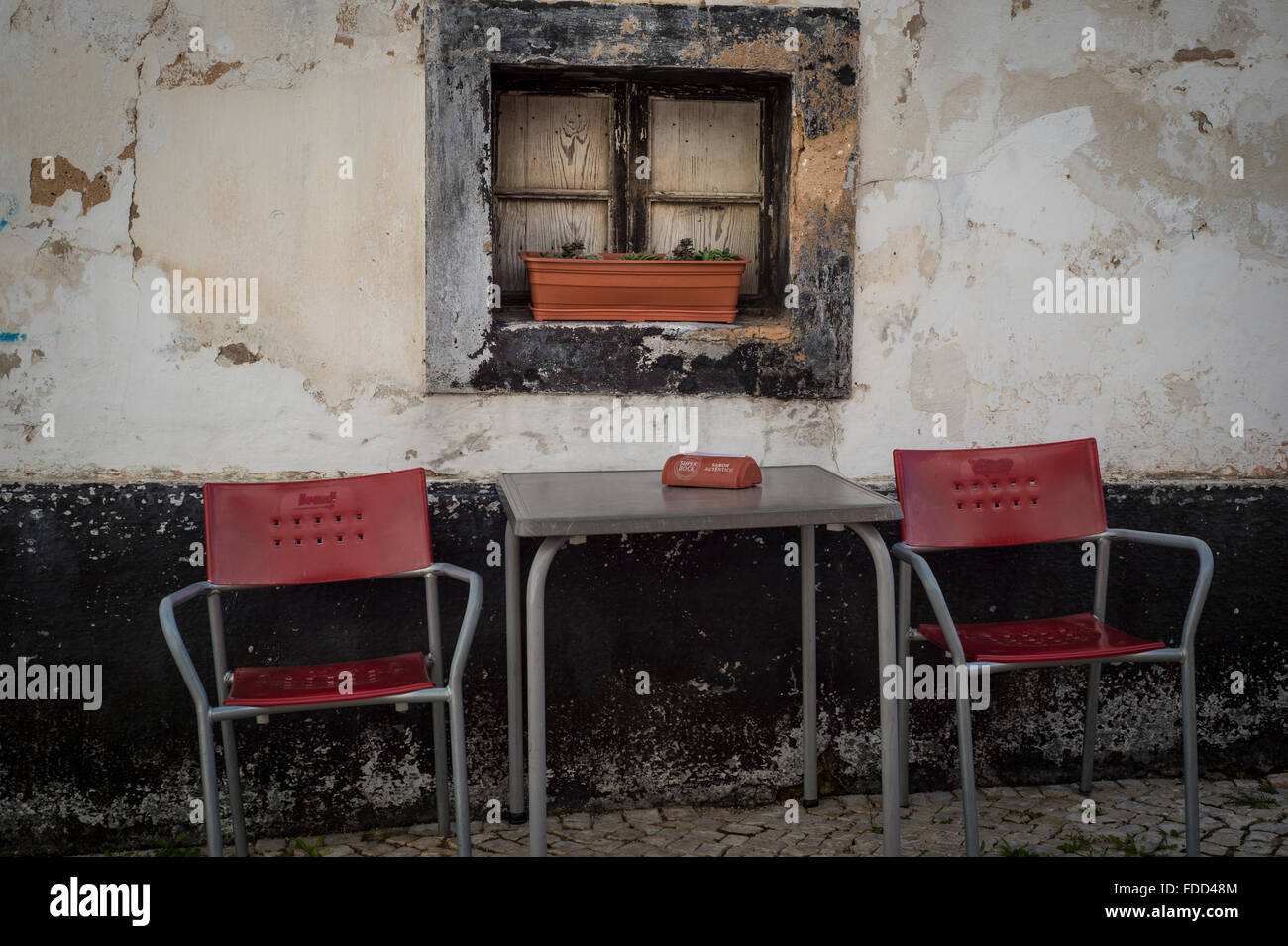 rustic table and chairs outside a cafe in the old town, Lagos, Portugal ...