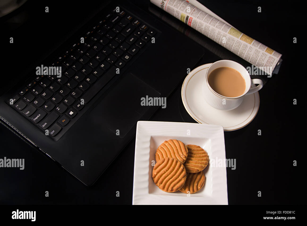 Office laptop and Tea Biscuit Breakfast nobody Stock Photo - Alamy