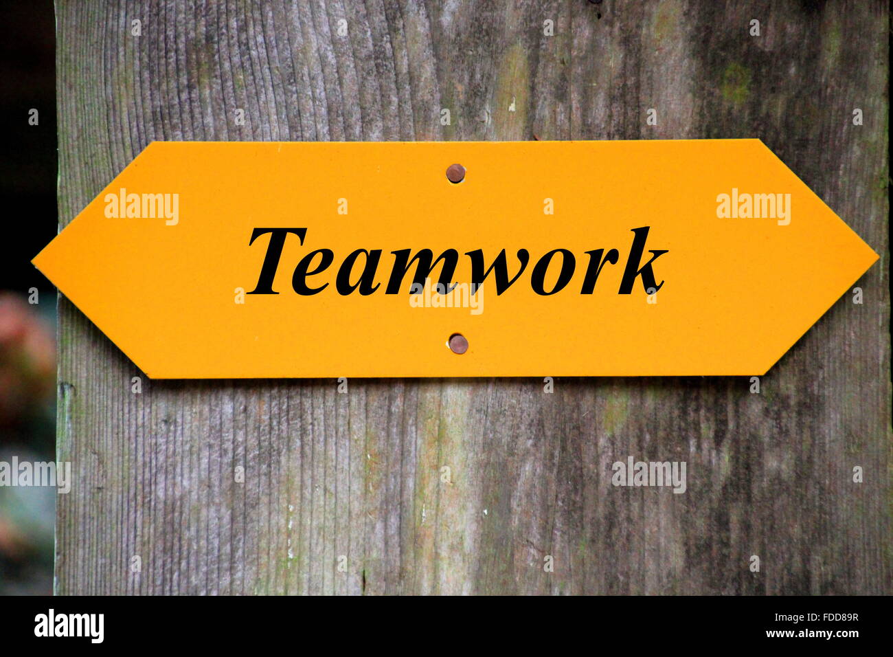 teamwork written on a yellow direction sign Stock Photo - Alamy